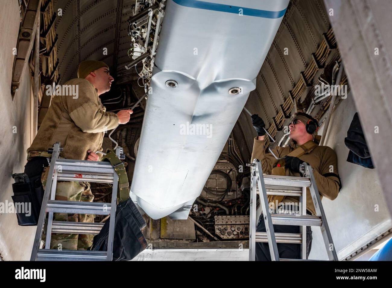 Weapons load crew members assigned to the 9th Aircraft Maintenance Unit ...