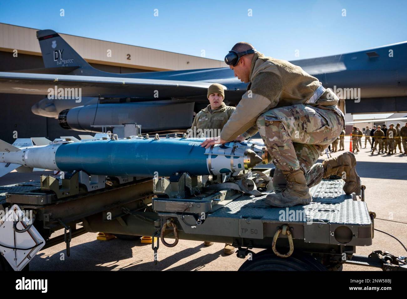 Weapons load crew members assigned to the 9th Aircraft Maintenance Unit ...