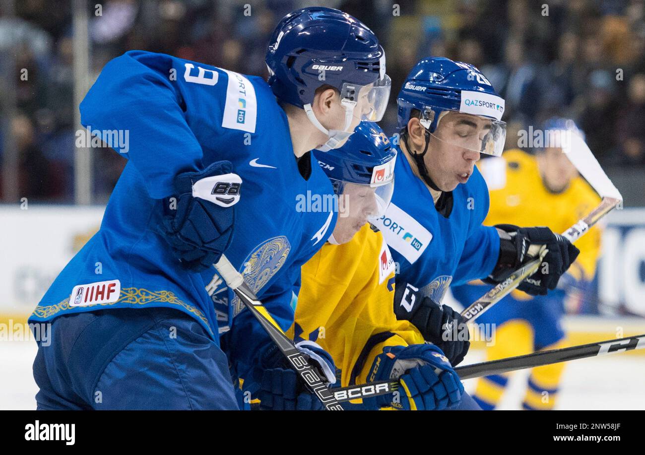 Kazakhstan's Ruslan Dyomin (26) and Valeri Orekhov (9) sandwich Sweden ...