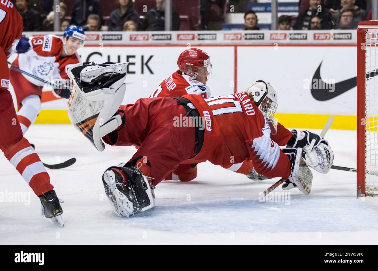 Denmark goalie Mads Soegaard, front, dives to stop Czech Republic's ...
