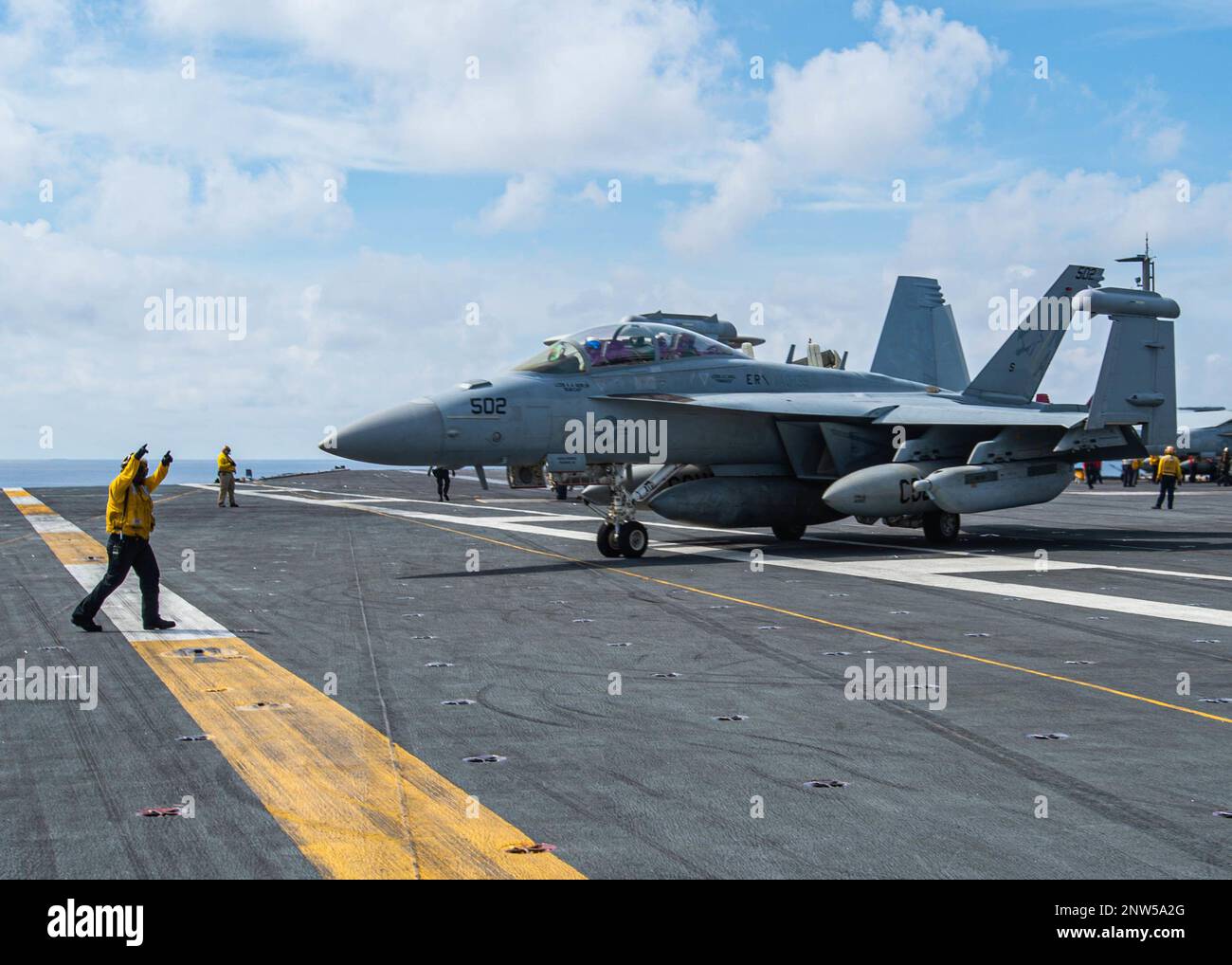 230114-N-MH015-1005 SOUTH CHINA SEA (Jan. 14, 2023) A U.S. Navy Sailor directs an E/A-18G ...
