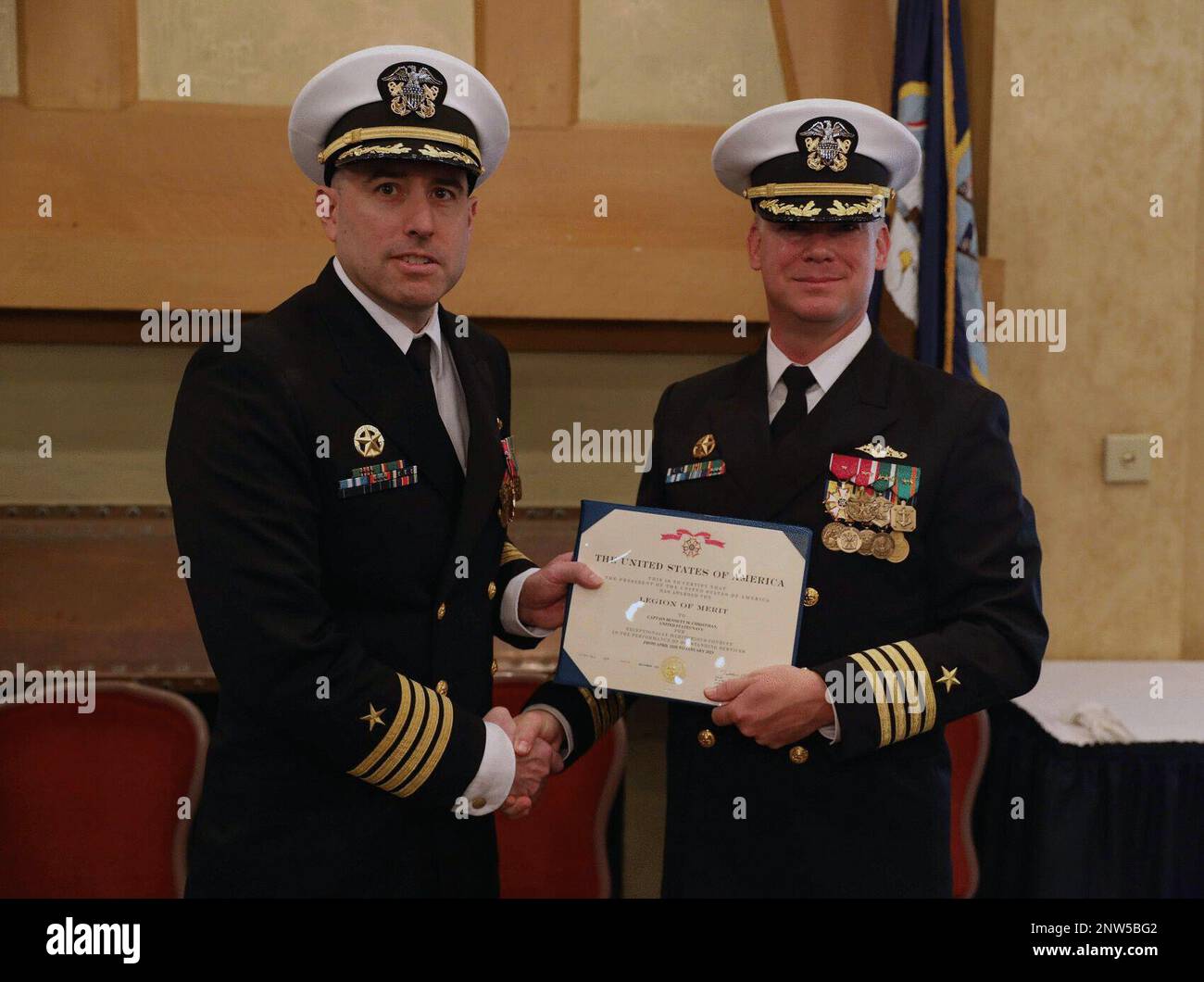 Capt. Jason Pittman, commodore, Submarine Squadron Six, right, presents ...