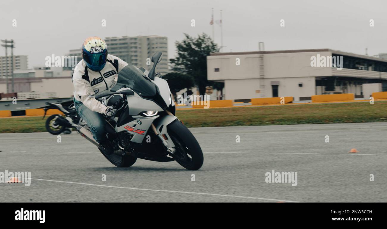 A U.S. service member rides their motorcycle through a training circuit ...