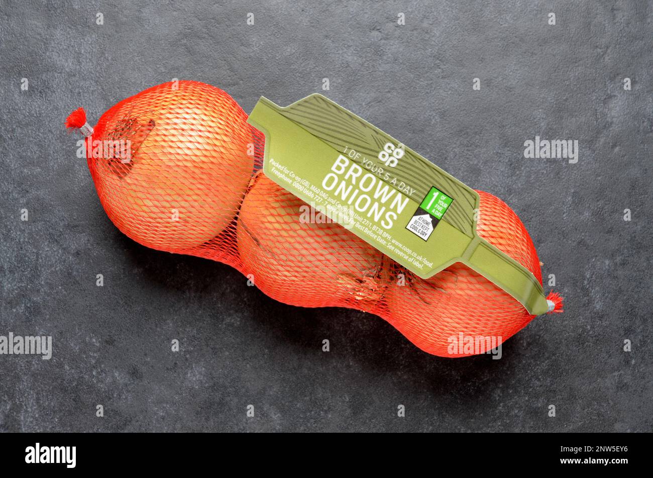 Three Brown Onions in Net Packaging from Co-Op Supermarket shot from ...