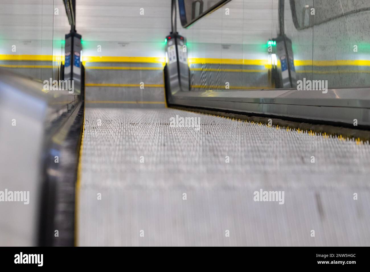 Escalators in an underground pedestrian passage. Close-up of steps ...