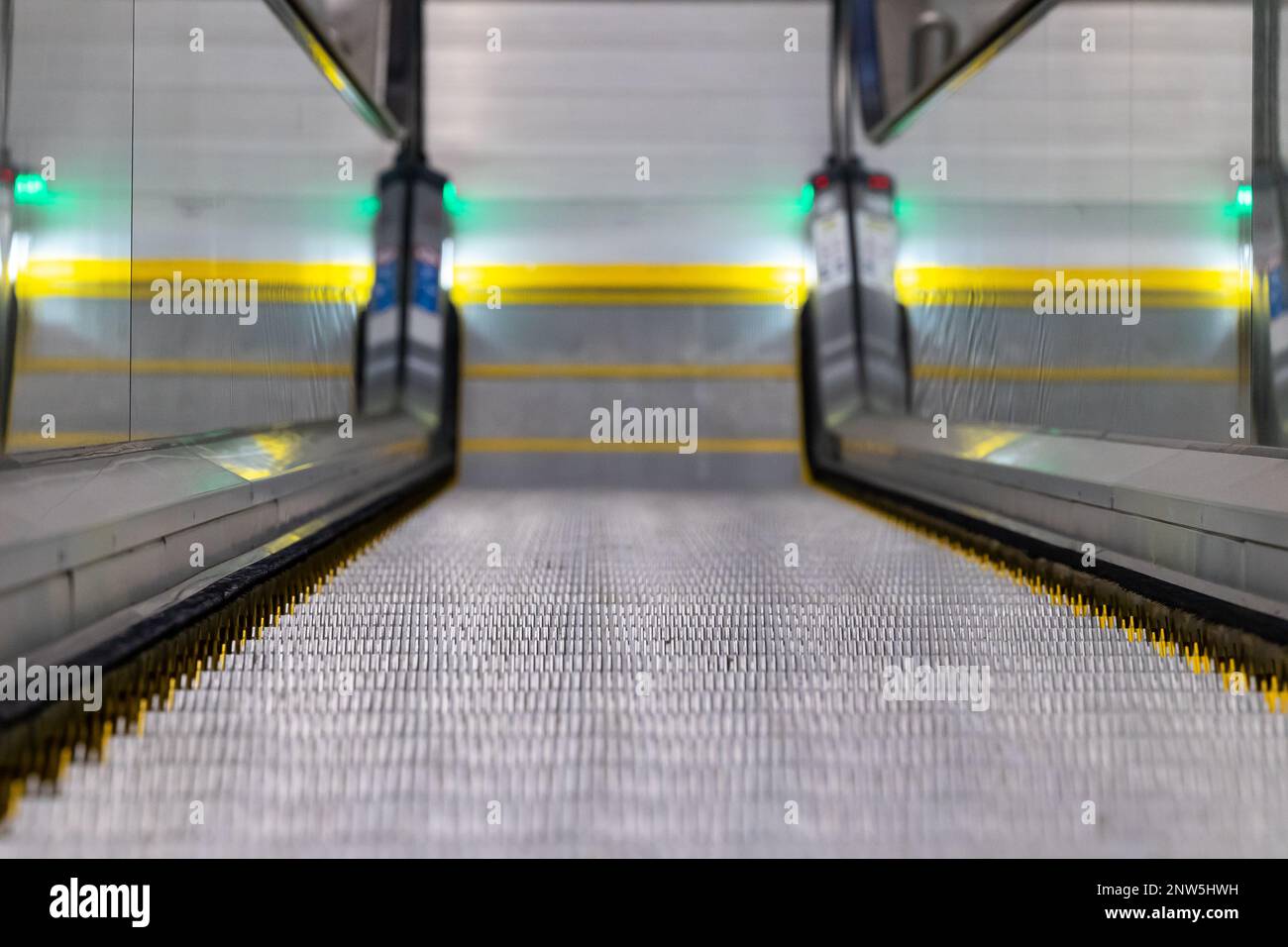 Escalators in an underground pedestrian passage. Close-up of steps ...