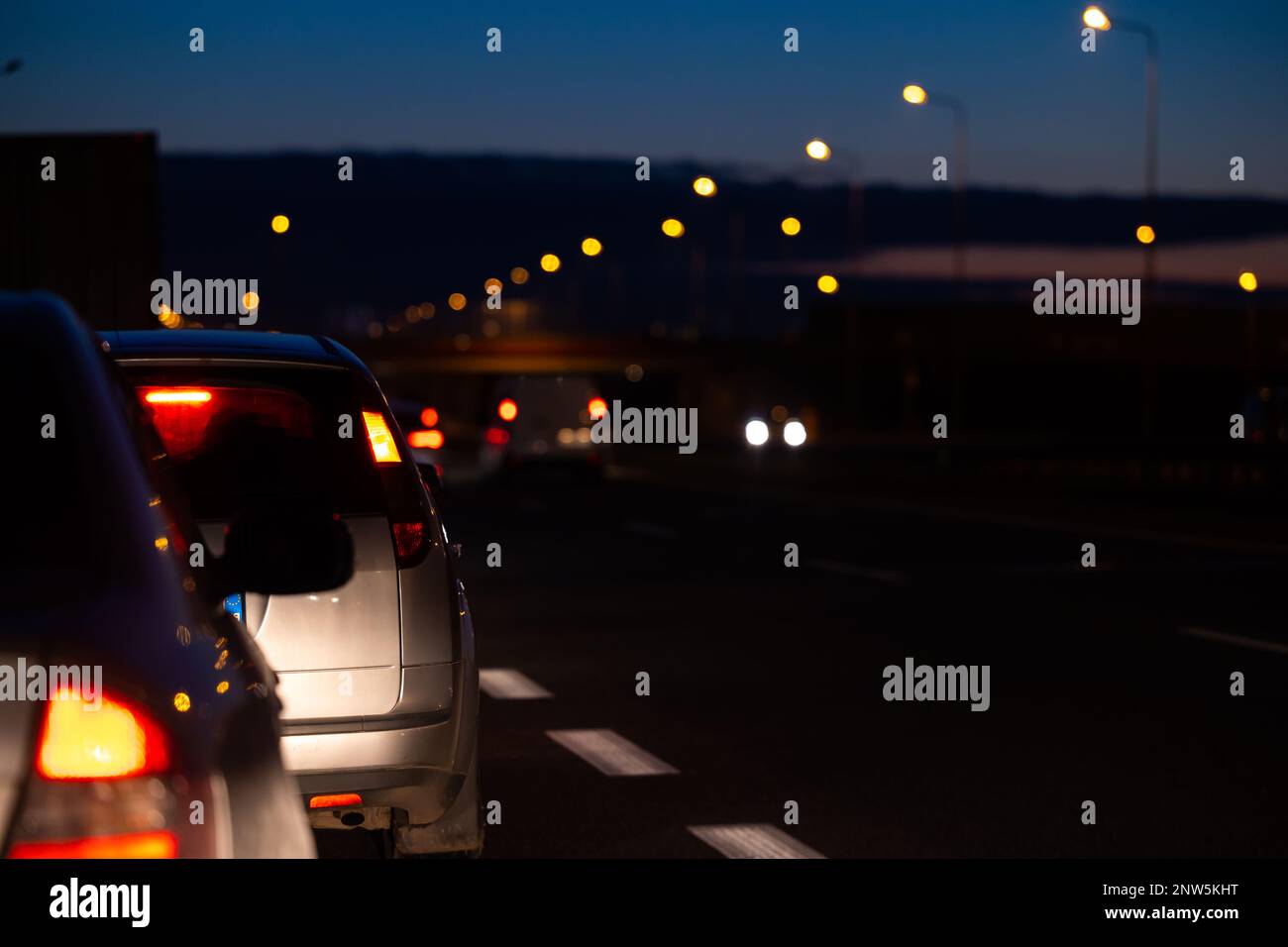 Cars in night traffic jams at highway exit. View of the vehicles from ...