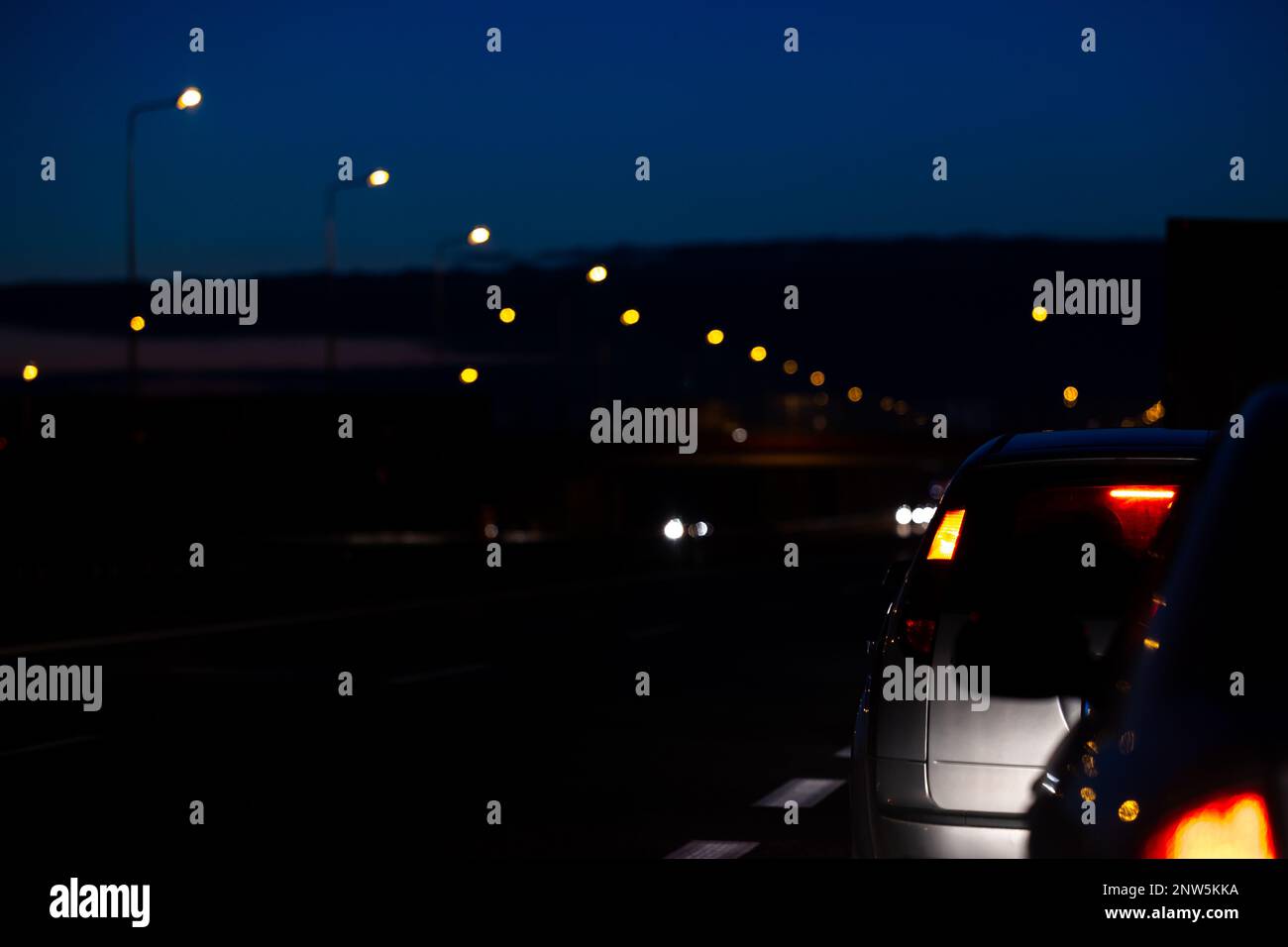 Cars in night traffic jams at highway exit. View of the vehicles from ...