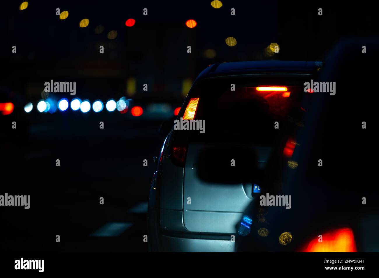 Cars in night traffic jams at highway exit. View of the vehicles from ...