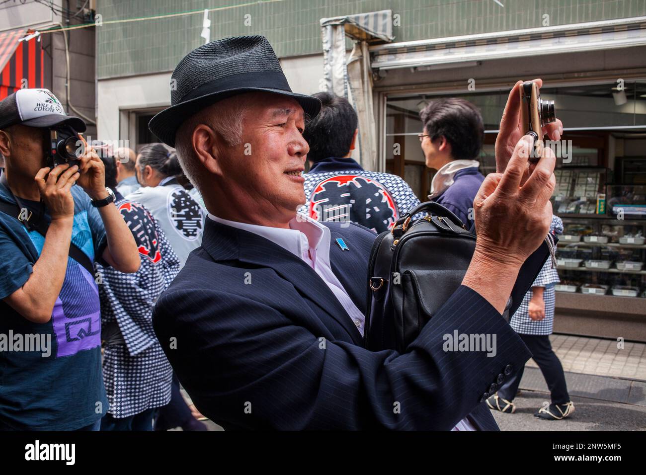 men taking pictures in Asakusa Chuo Dori Street,next to Sensoji Temple ...