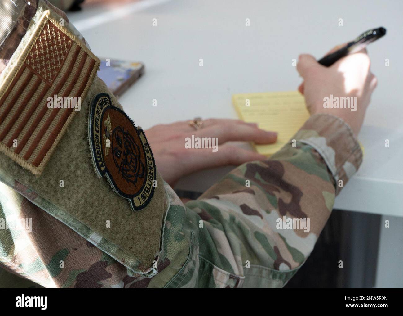 An Airman assigned to the 7th Intelligence Squadron takes notes during ...