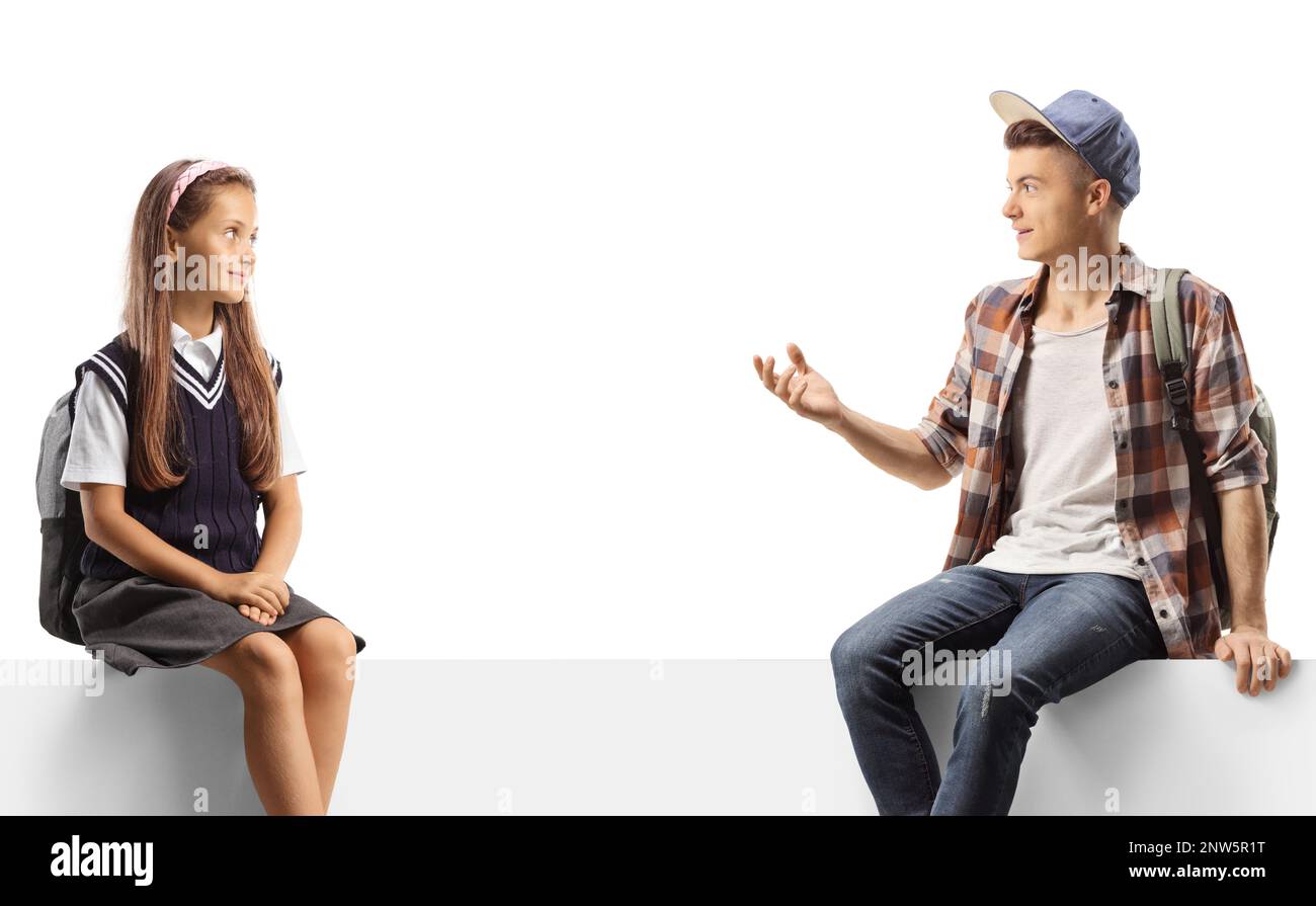 Schoolgirl and a male student seated on a panel having a conversation ...