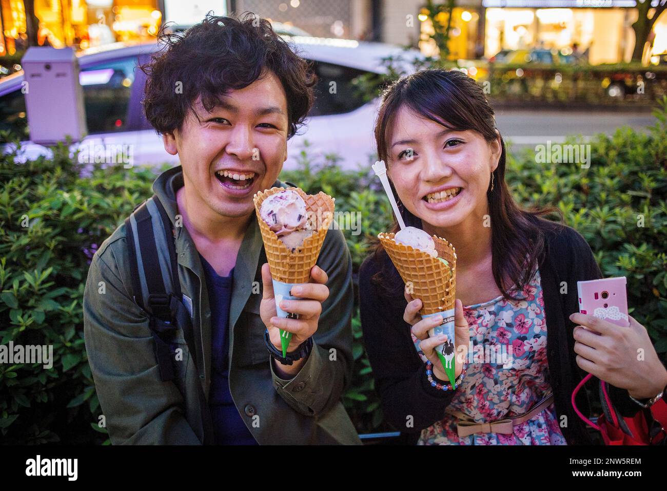 Couple eating Ben & Jerry's ice cream, in Omotesando street. Tokyo ...