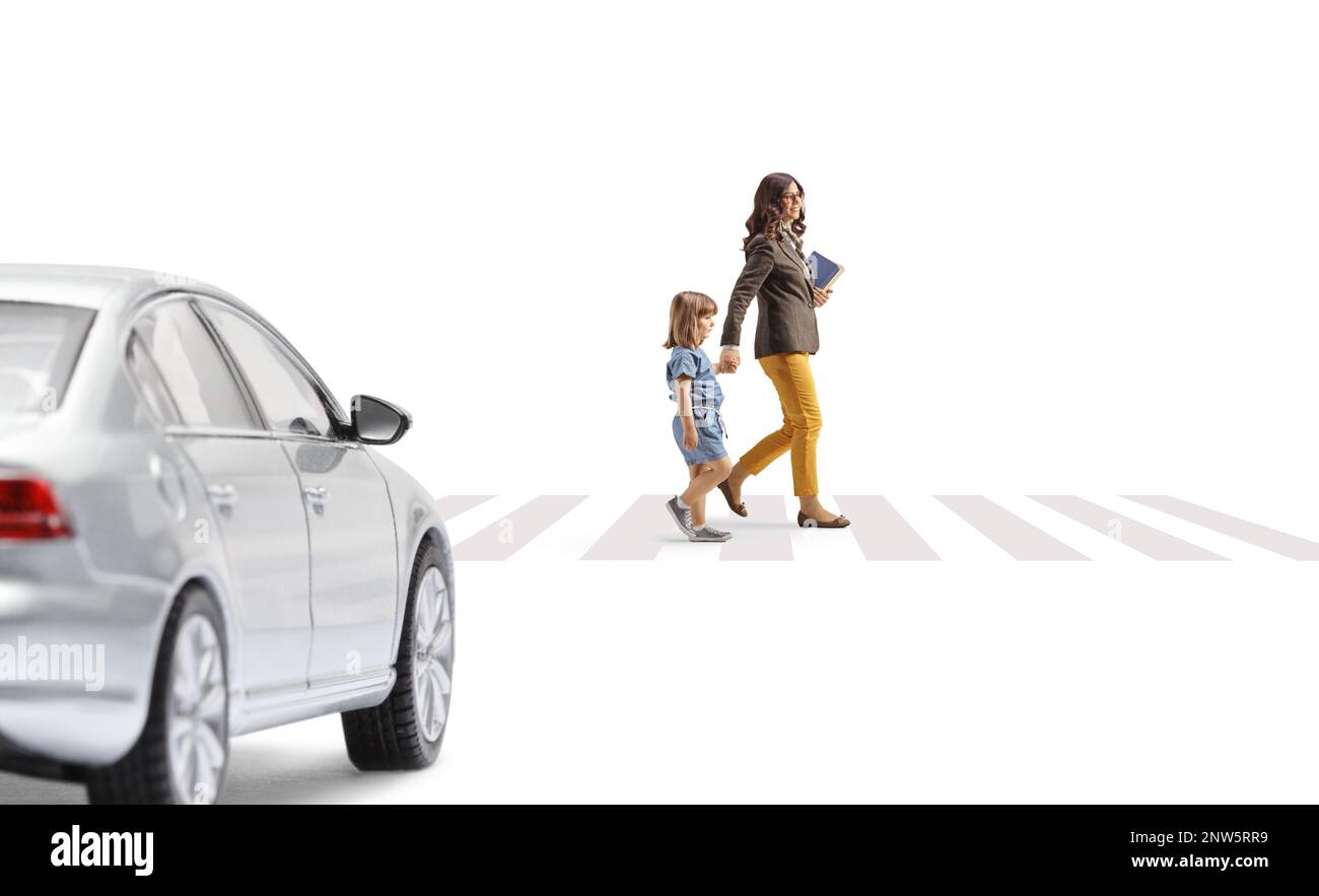 Car driving towards a pedestrian crossing and woman walking with a ...