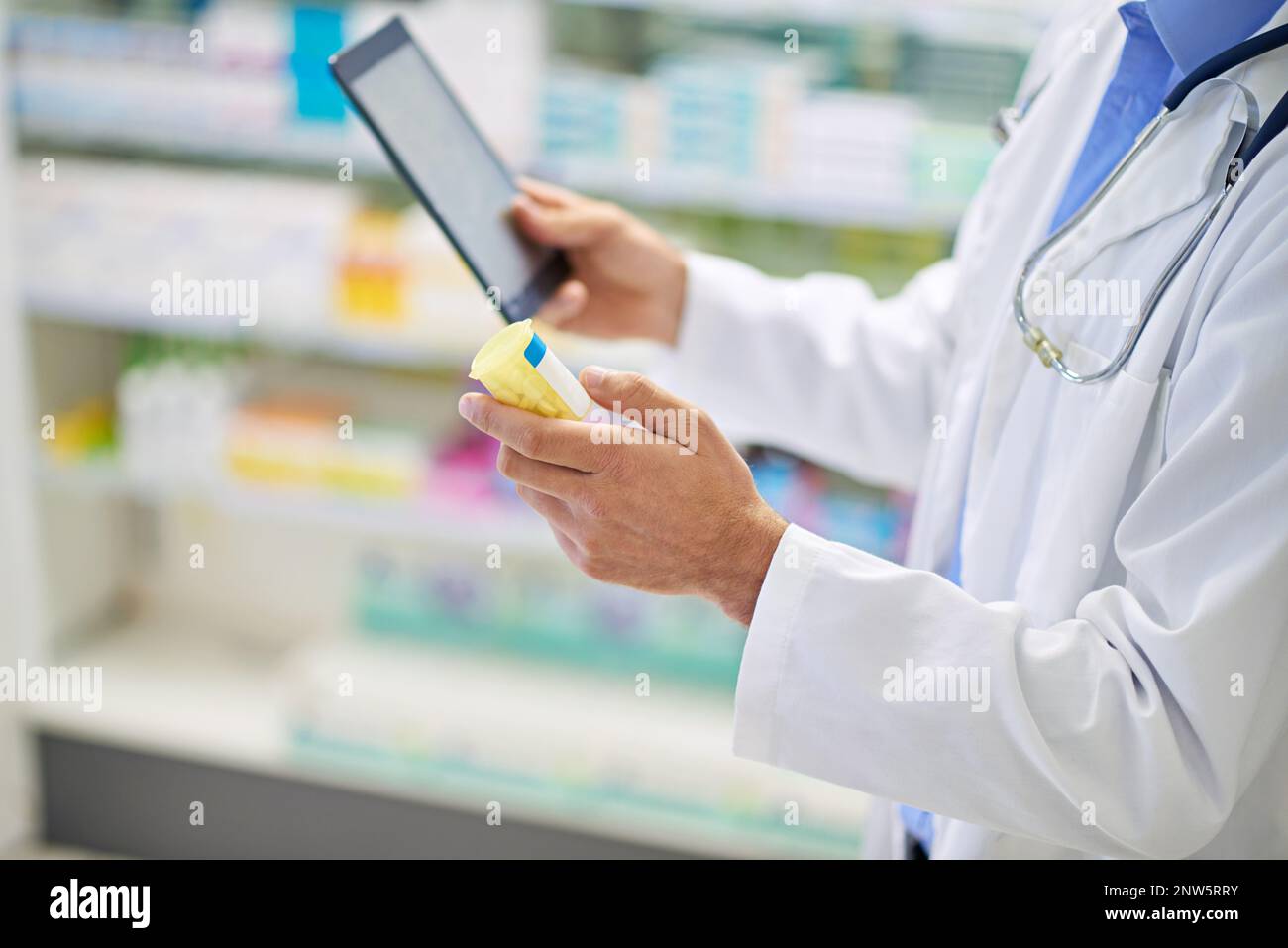 Trusting modern technology to do the thinking. A pharmacist working on ...