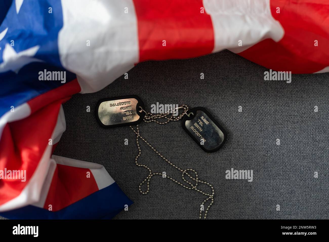 Army tokens on American national flag background Stock Photo - Alamy