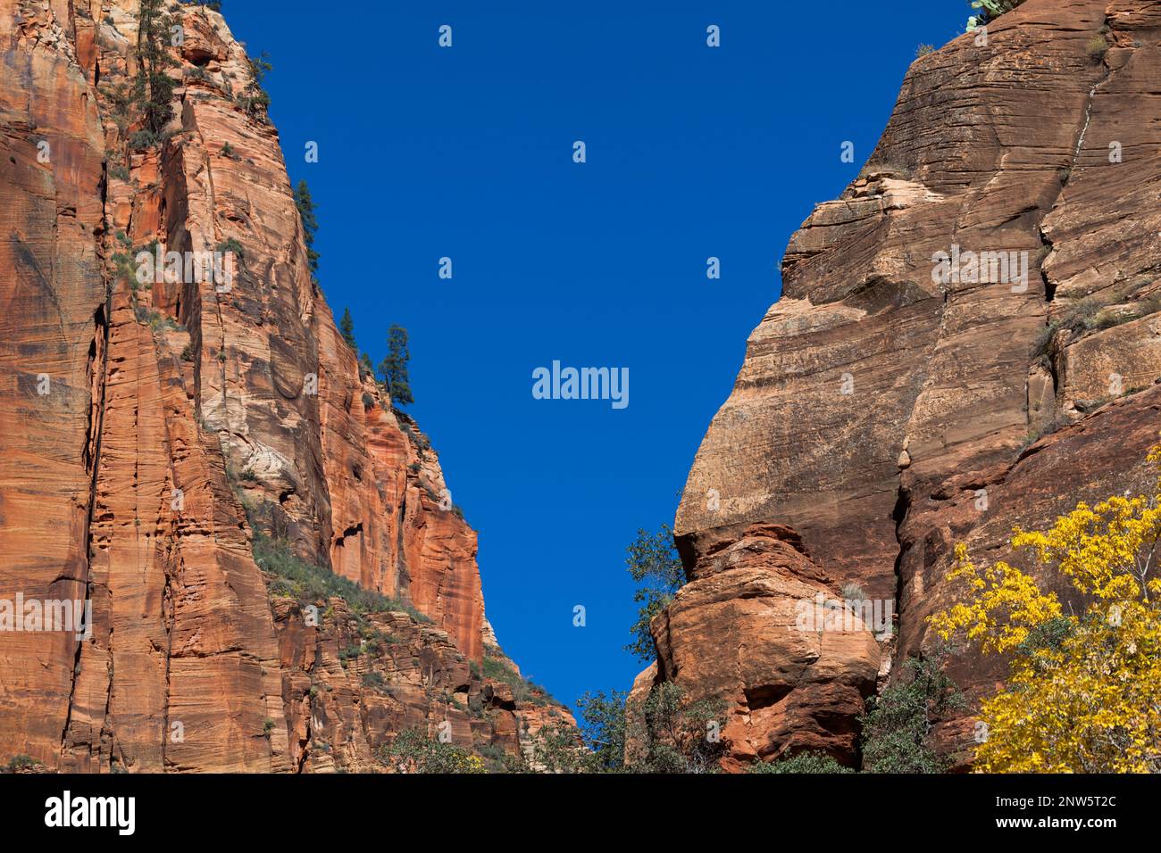 Dramatic orange and brown cliffs come together to form a V shape of ...