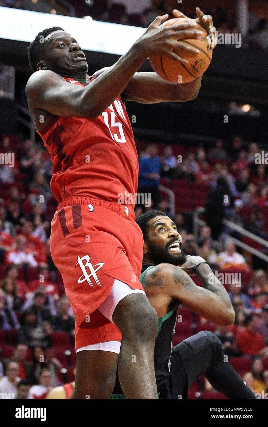 Houston Rockets center Clint Capela, left, grabs a rebound above Boston ...