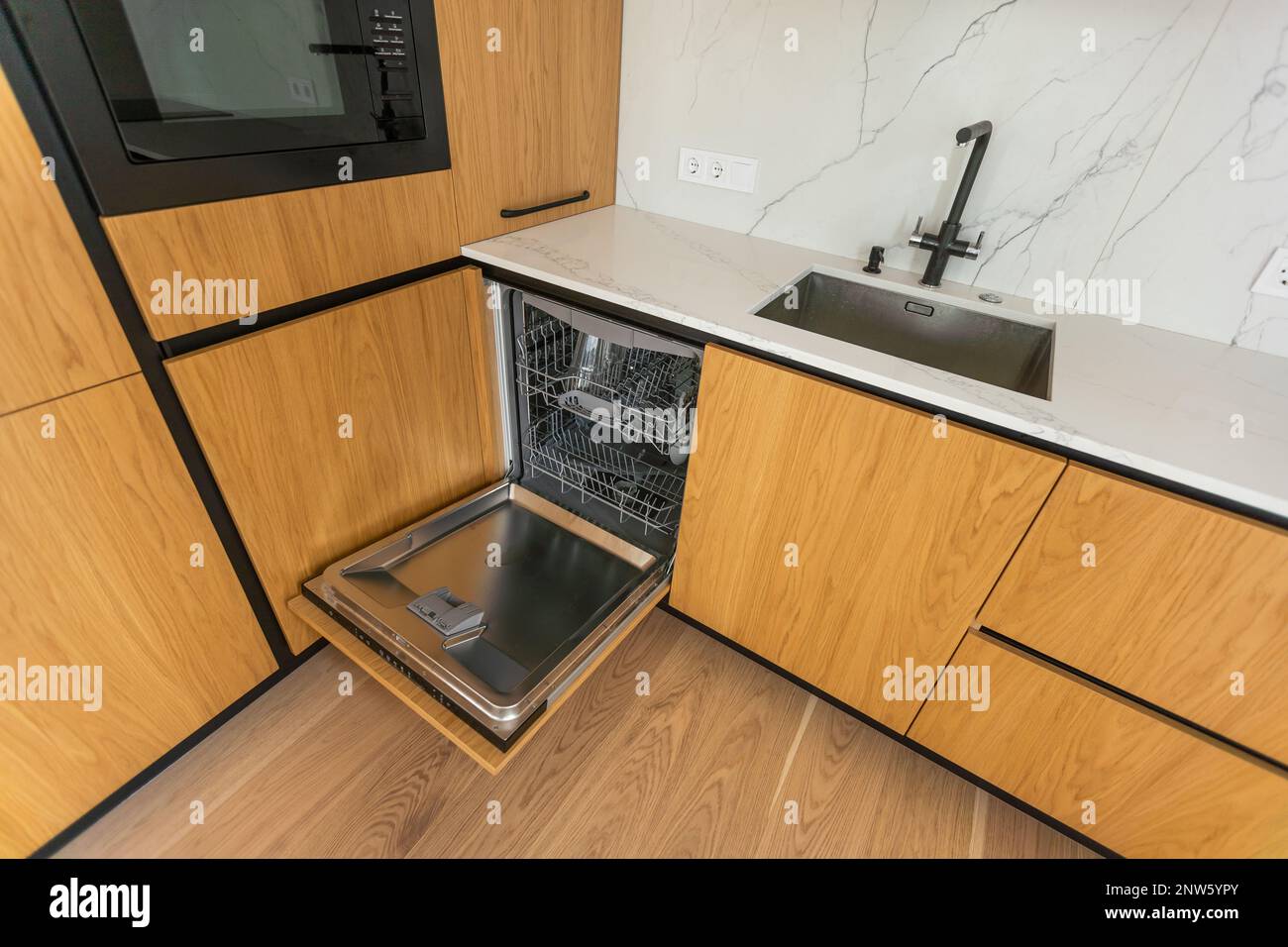 Open door of built-in dishwasher. Kitchen with integrated appliances ...