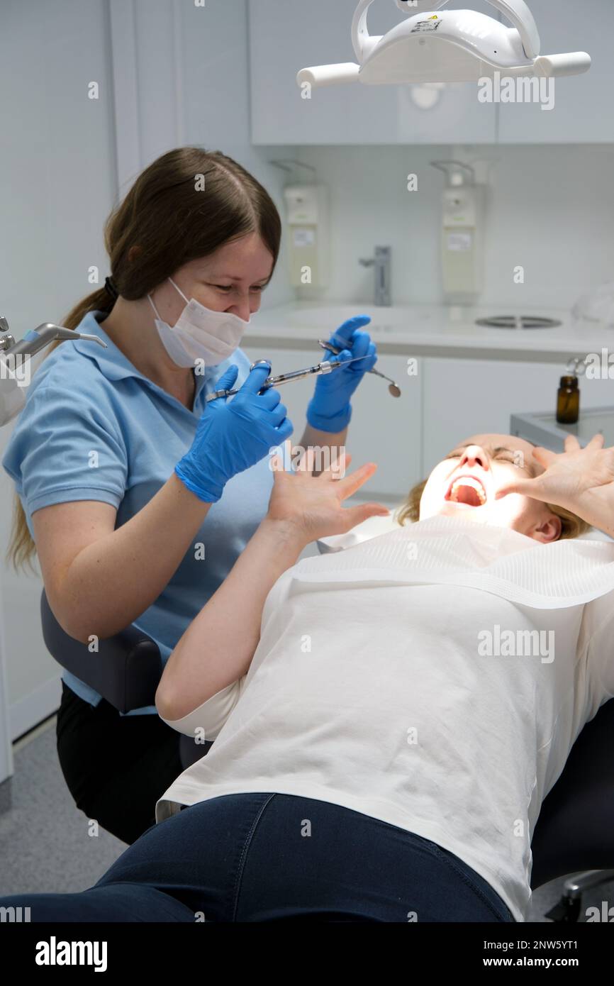 comic photo in dentistry a woman screams and is afraid of a doctor's ...