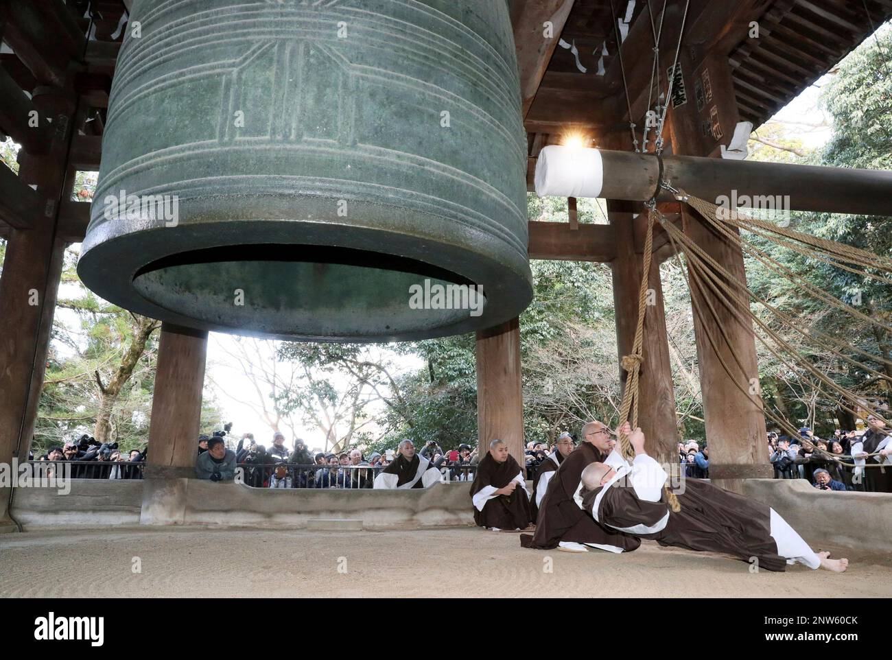 Buddhist monks use a rope to toll a giant New Year's Eve bell at Chion ...
