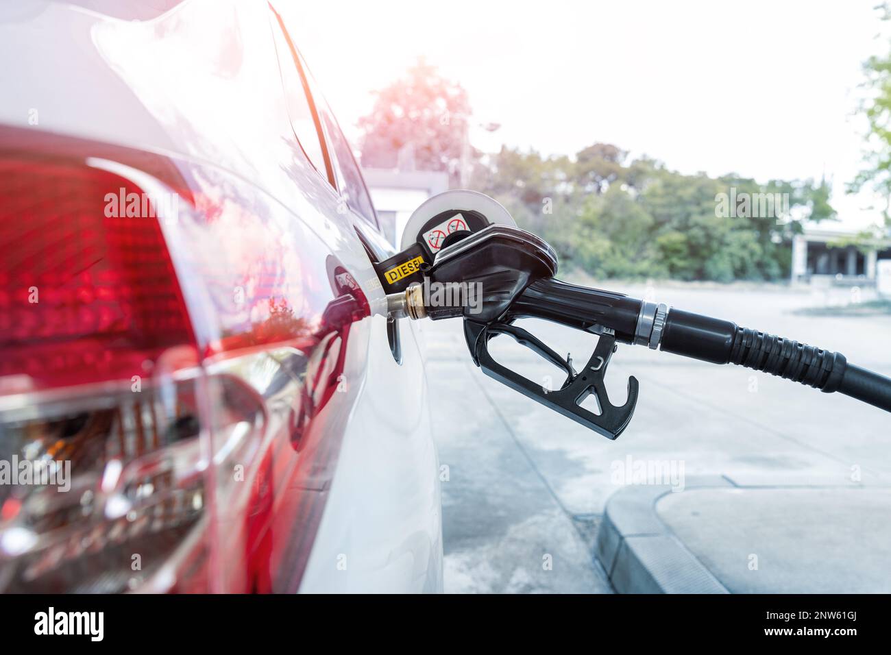 Close-up detail view of black pistol handle inserted in white diesel ...