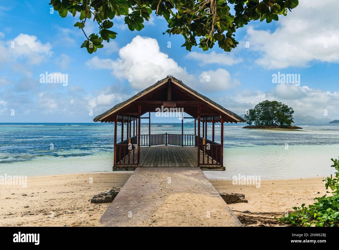 Small jetty or wooden boathouse on empty tropical sandy beach on La ...