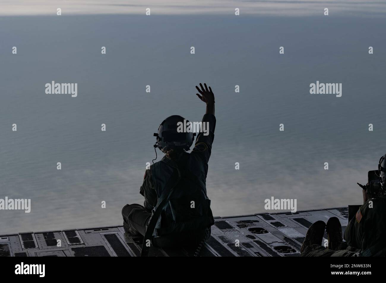 U.S. Air Force Senior Airman Aleea Barreras, a loadmaster from the 14th Airlift Squadron, waves ...
