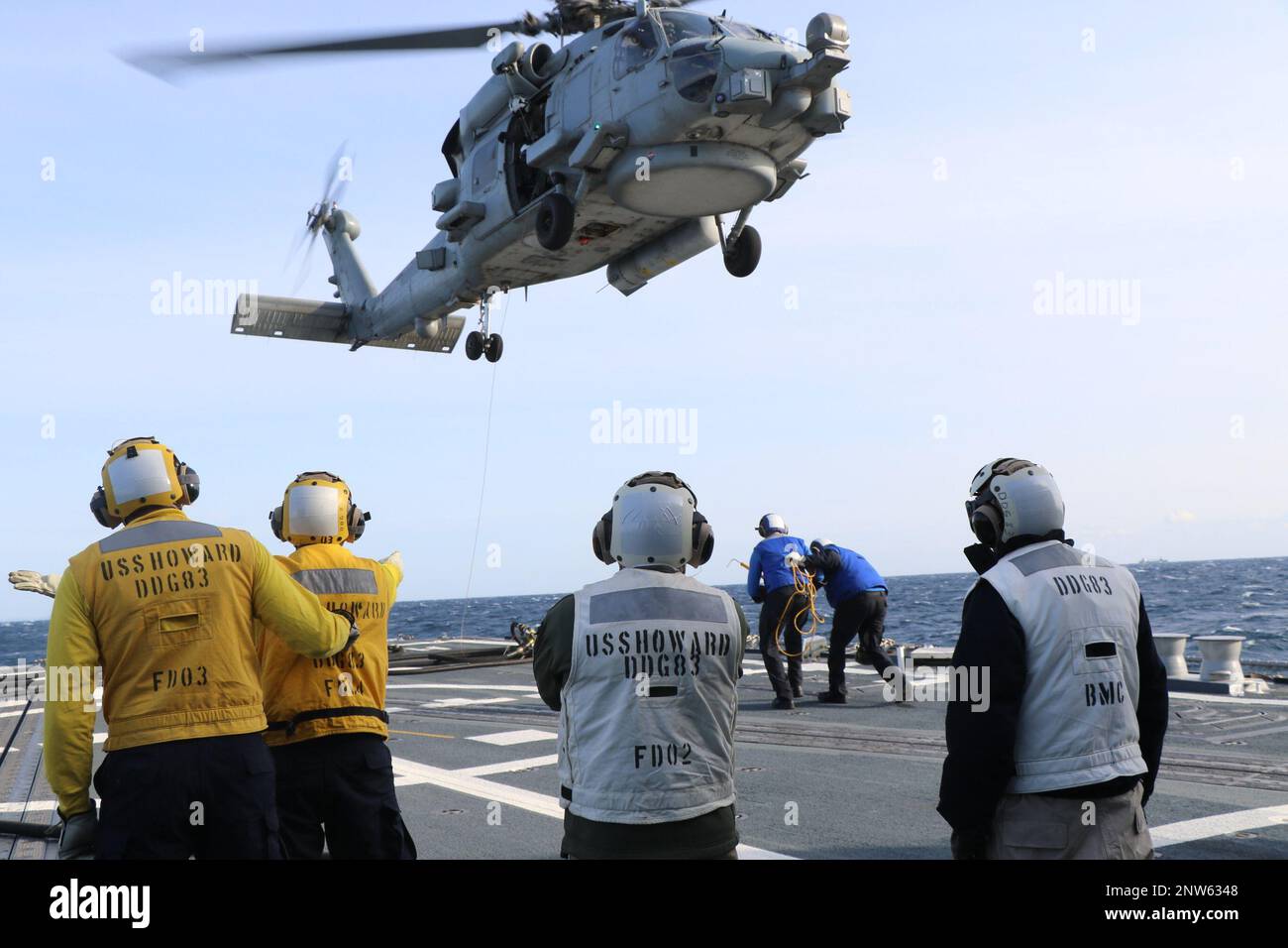 SAGAMI WAN, Japan (Jan. 23, 2023) Howard Sailors and a MH-60R Seahawk ...