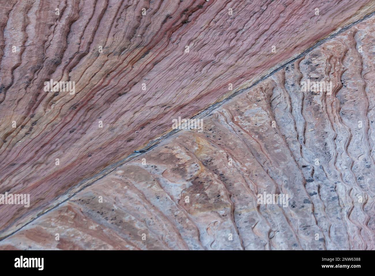 Layers of ancient sandstone rock in pastel colors in Zion National Park ...