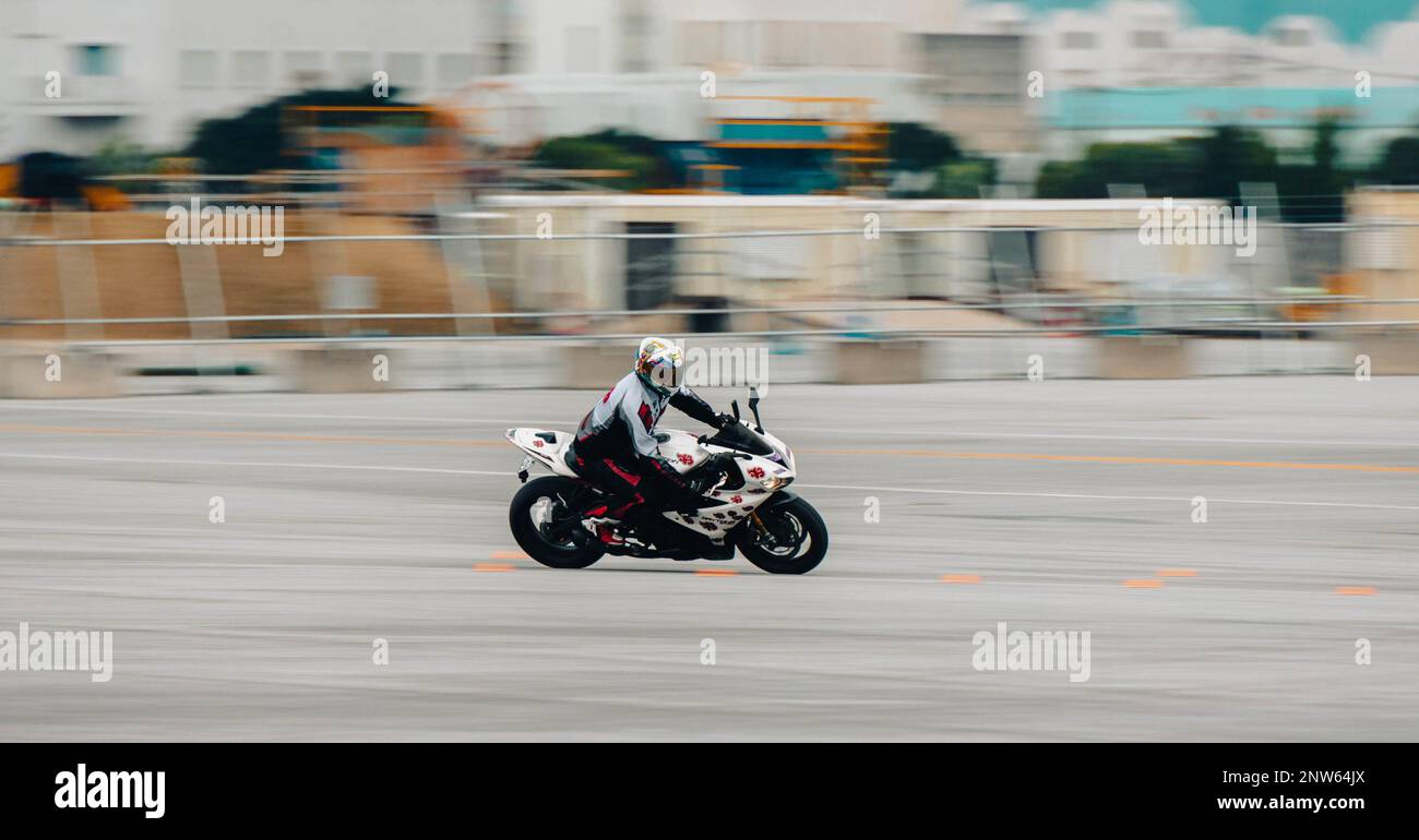 A U.S. service member rides their motorcycle through a training circuit ...
