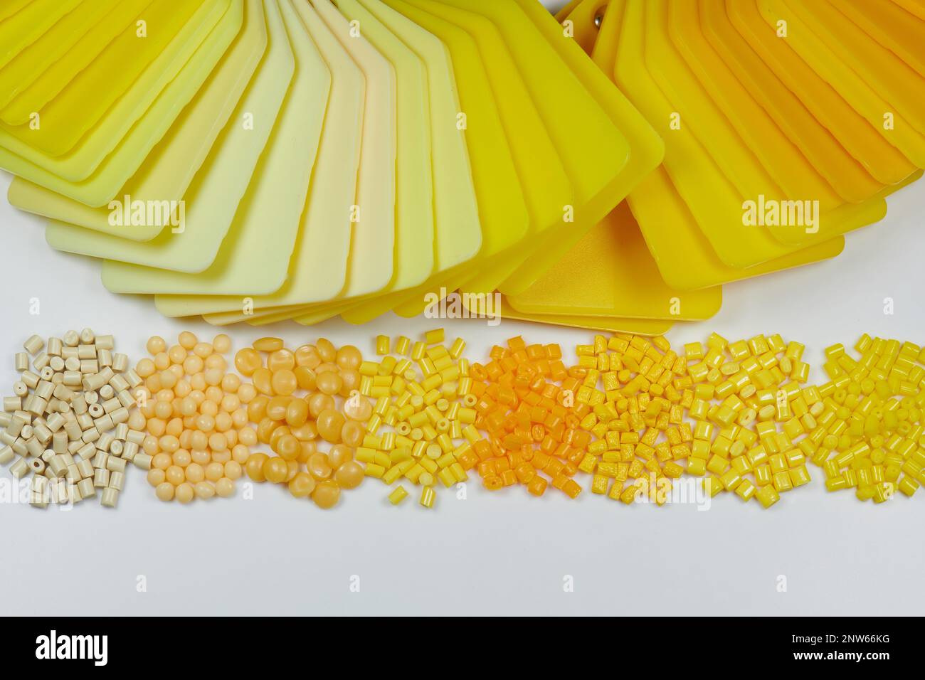 different yellow plastic polymer resin granulates with samples in ...