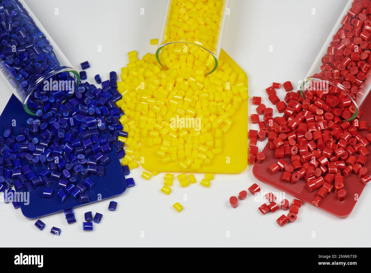 Blue, yellow and red colored plastic resins in test tubes in laboratory ...
