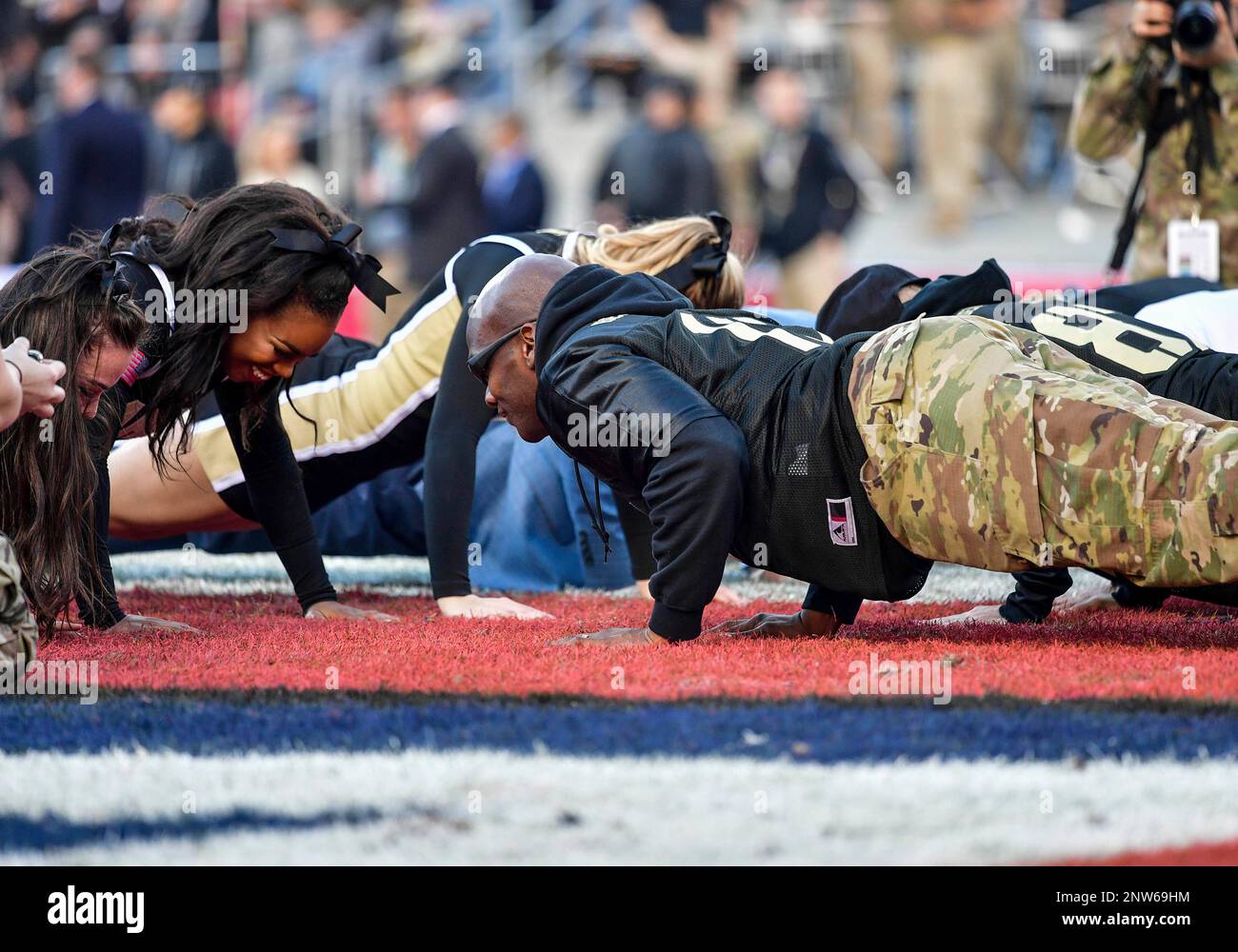 Army cheer squad doing push-ups after a touchdown during the Lockheed ...