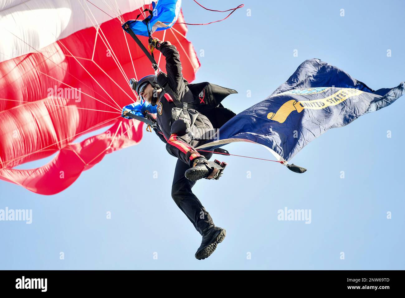 A member of the United States military parachutes onto the field during ...