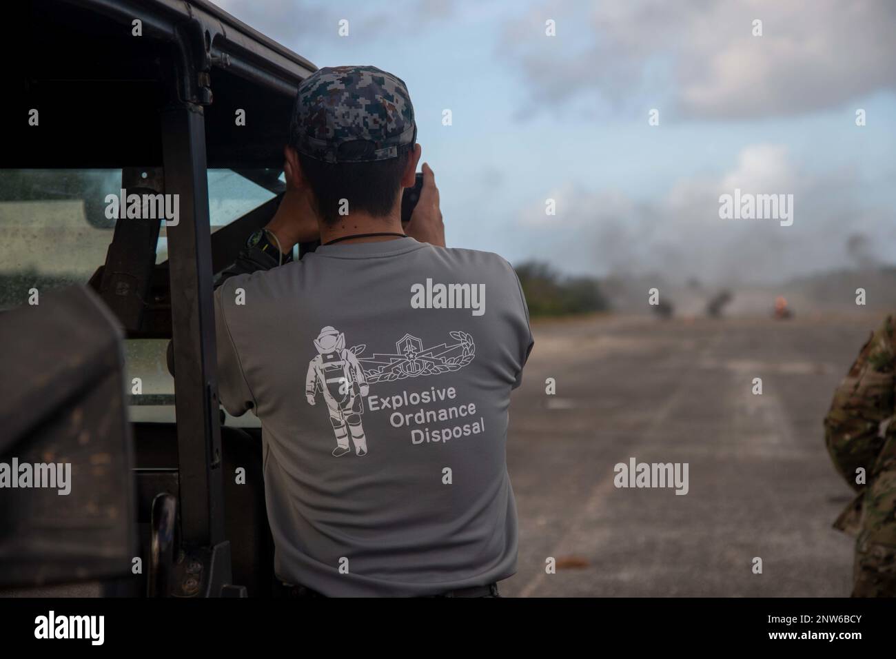 A member of the Japan Air Self-Defense Force (JASDF) takes a photo of a ...