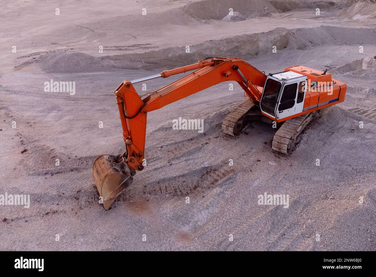 Excavator machine working in a quarry seen from above Stock Photo - Alamy