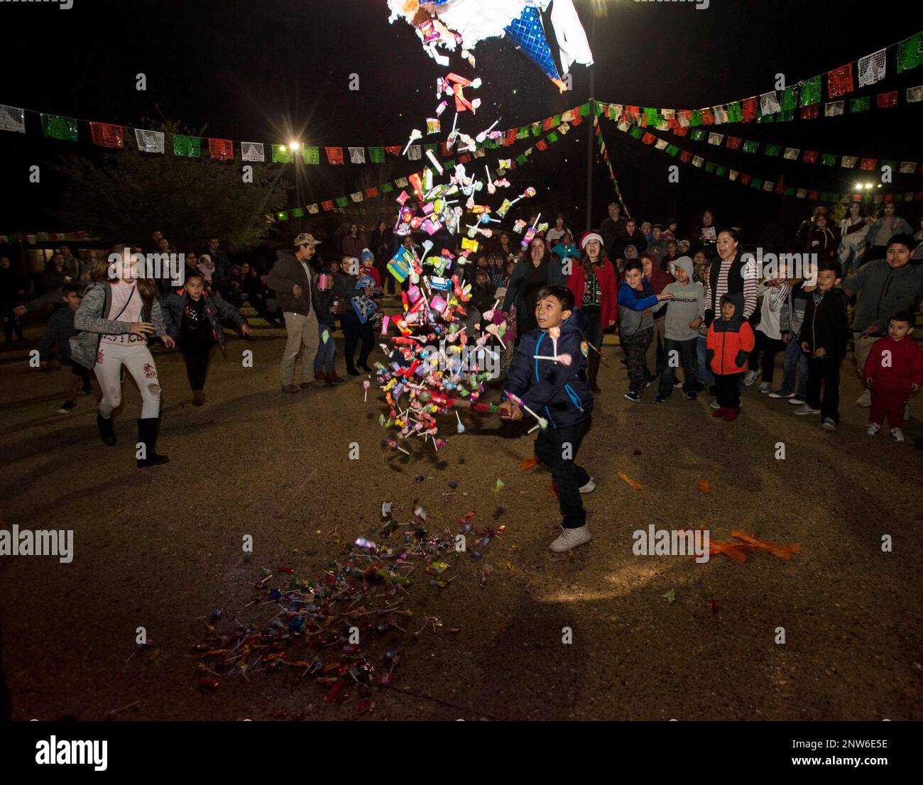Miguel Valencia, 9, spills candy from a piñata during Las Posadas at St ...