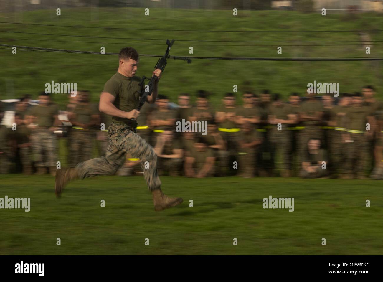 A U.S. Marine with 11th Marine Regiment, 1st Marine Division, runs with ...