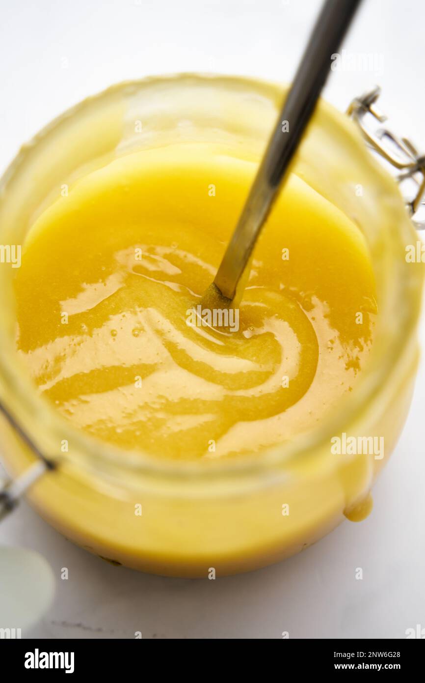 Lemon curd in a jar, spoon sticking out of the jar, top view Stock ...