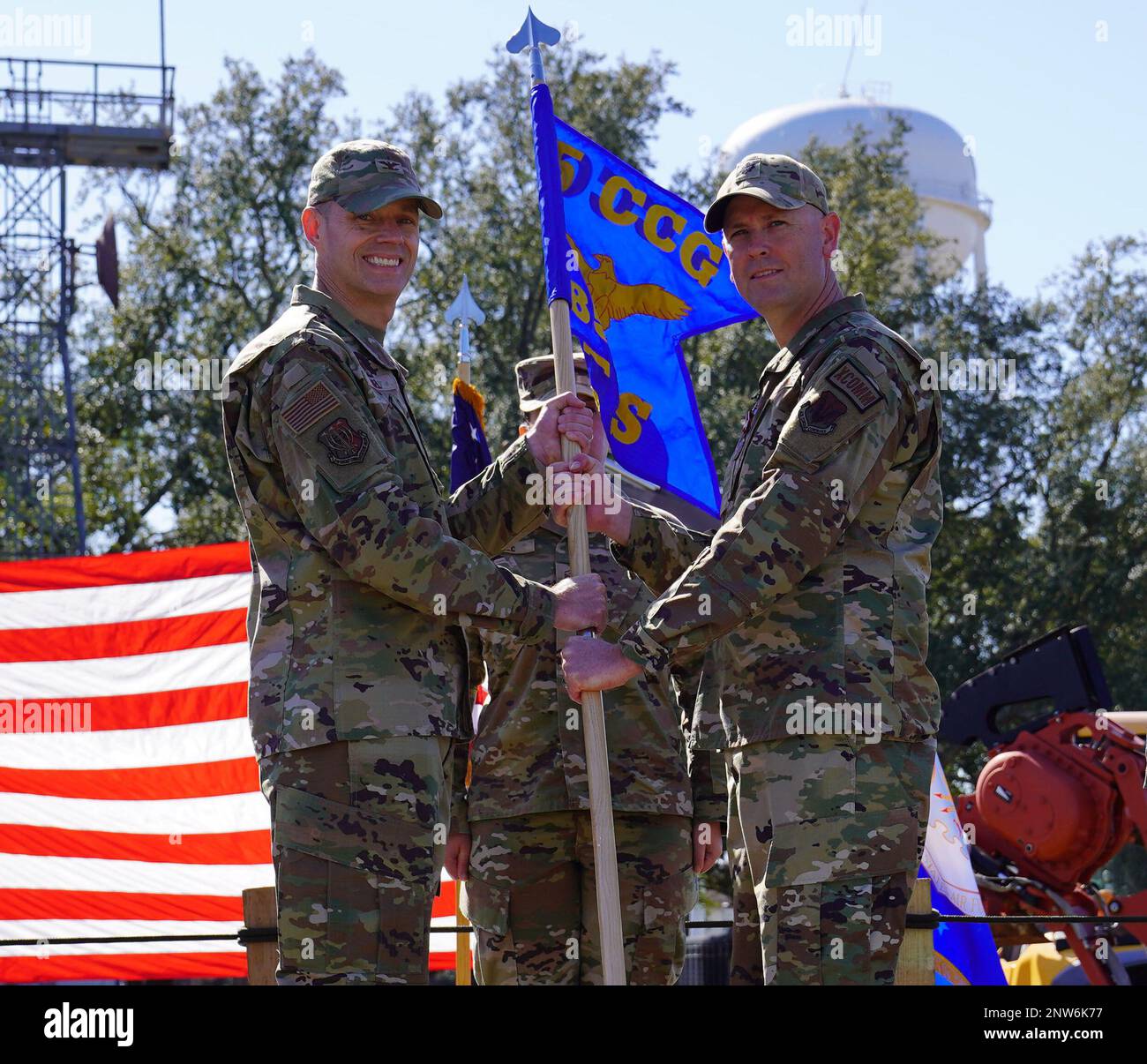 U.S. Air Force Col. Dave Abel, 5th Combat Communications Group commander, takes the guidon from ...