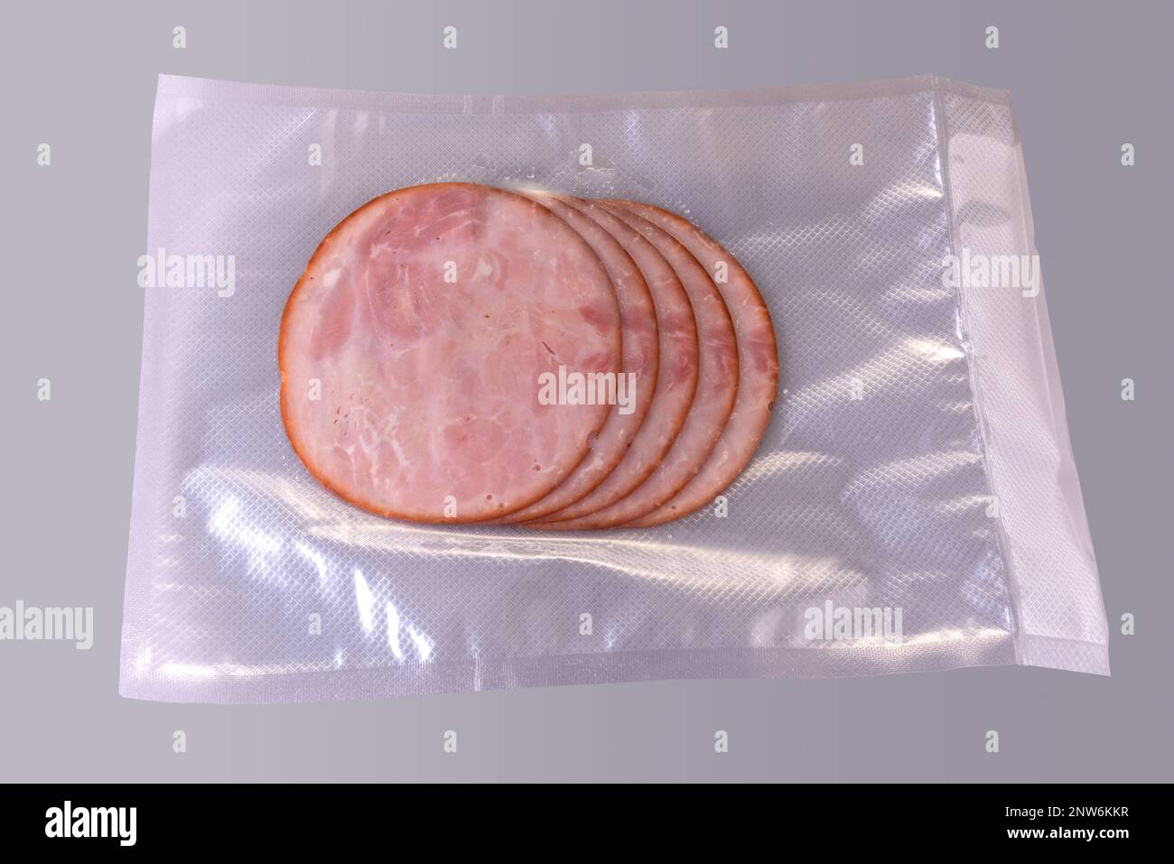 Smoked Ham Slices in vacuum pack for sous vide cooking on gray ...