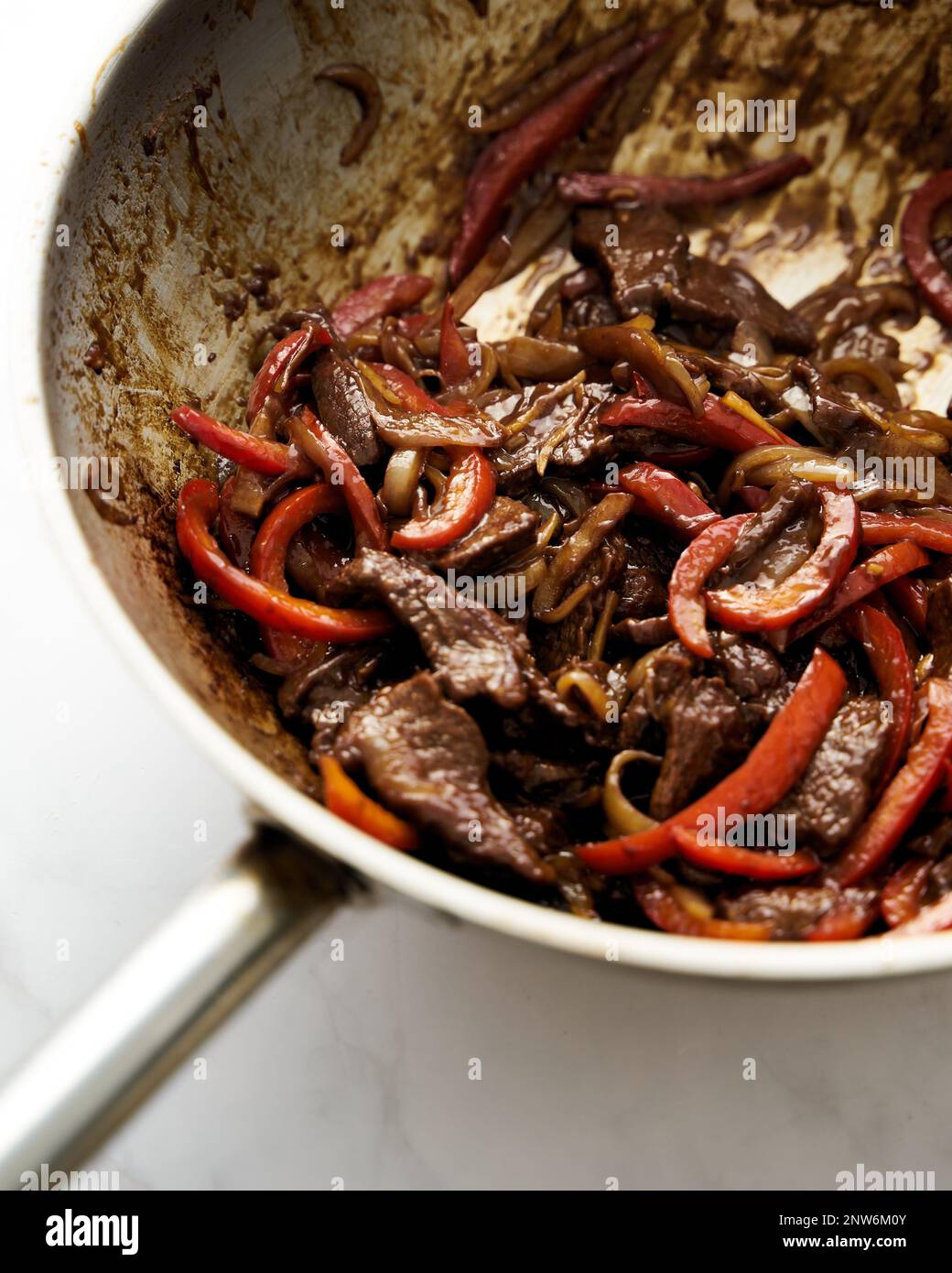 Chopped Hawaiian steak in wok with carrots and other vegetables. Sticky ...