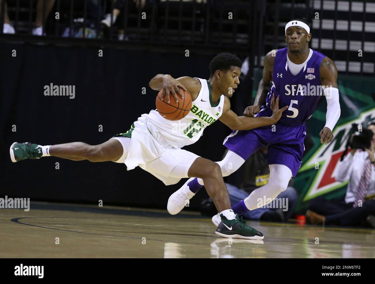 Baylor guard Jared Butler, left, pulls up before shooting over Stephen ...