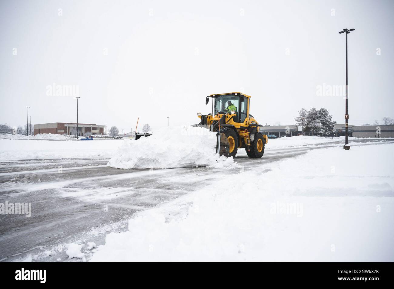 A snowplow operator from the 88th Civil Engineer Squadron clears the ...