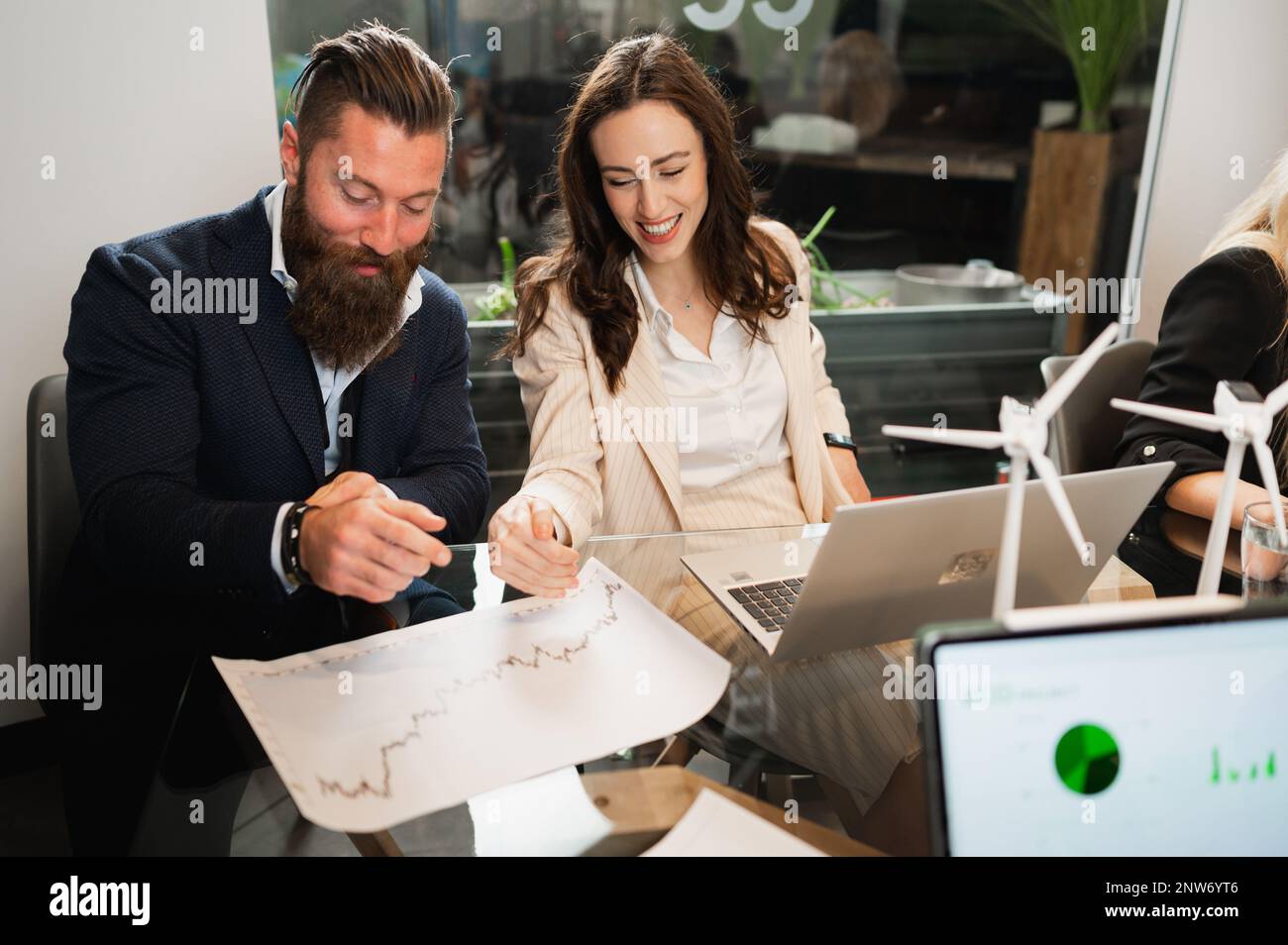 couple of young colleagues working together with happy positive faces ...
