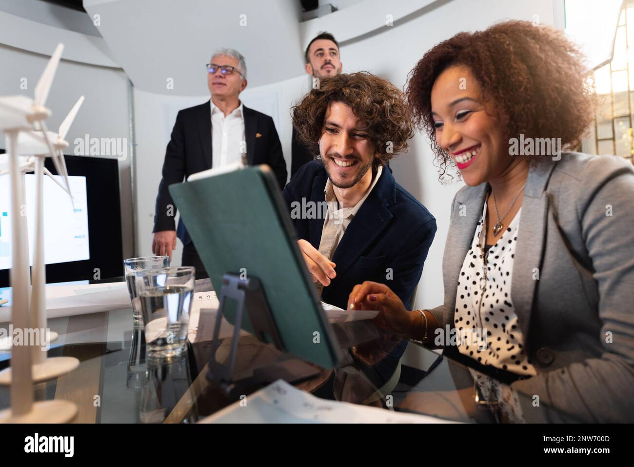 Happy teamwork planning a new project of renewable energy. Multiracial ...