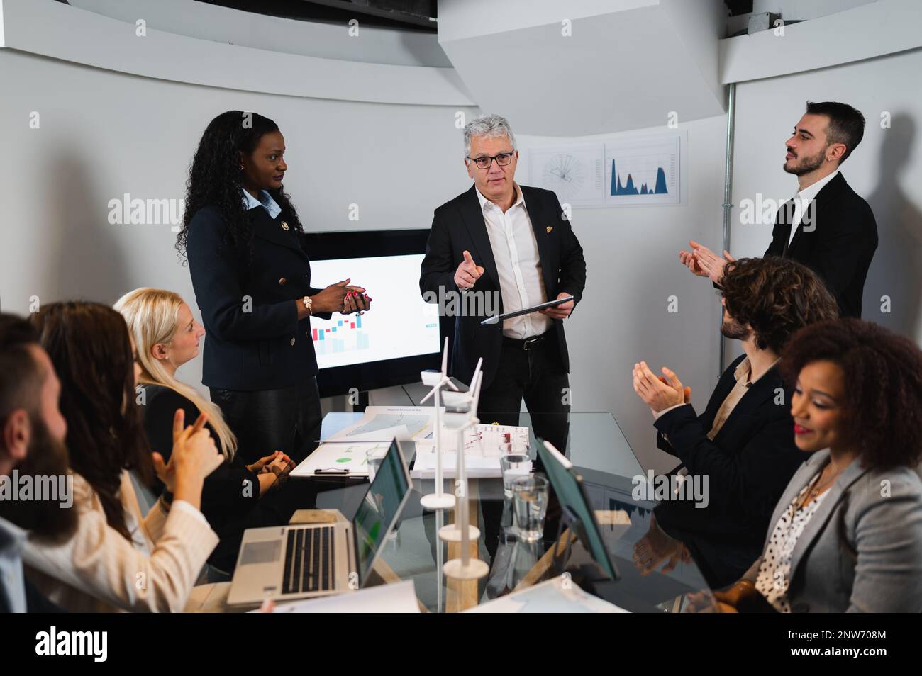 African businesswoman and senior businessman having a briefing meeting ...