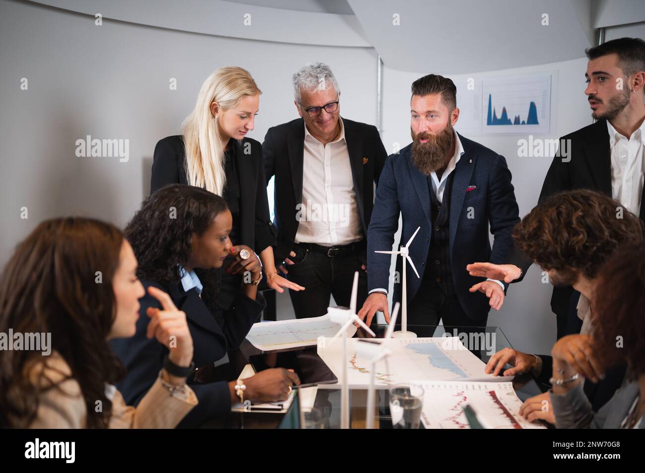 mixed group of colleagues discussing and planning new project in ...