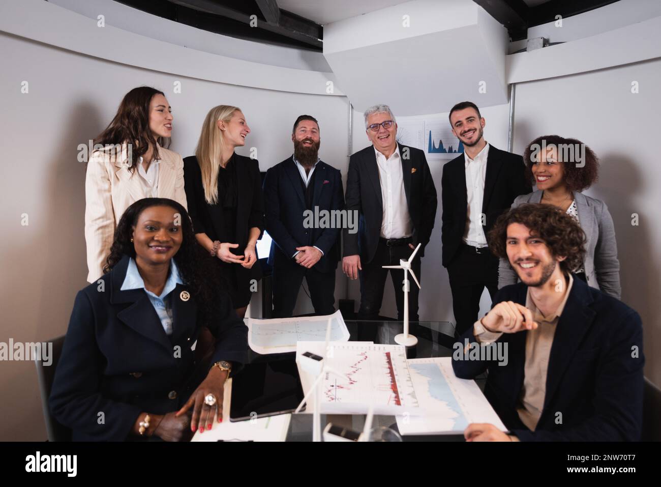 Real spontaneous portrait of mixed race elegant teamwork at workplace ...